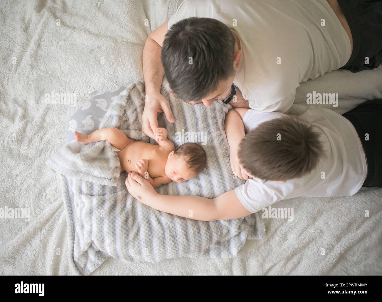 Portrait of father and his four son holding his newborn baby Stock Photo - Alamy