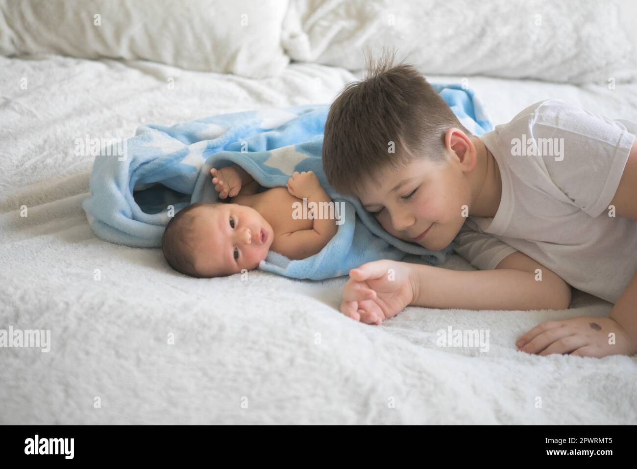 happy little kid boy with his newborn baby brother Stock Photo - Alamy