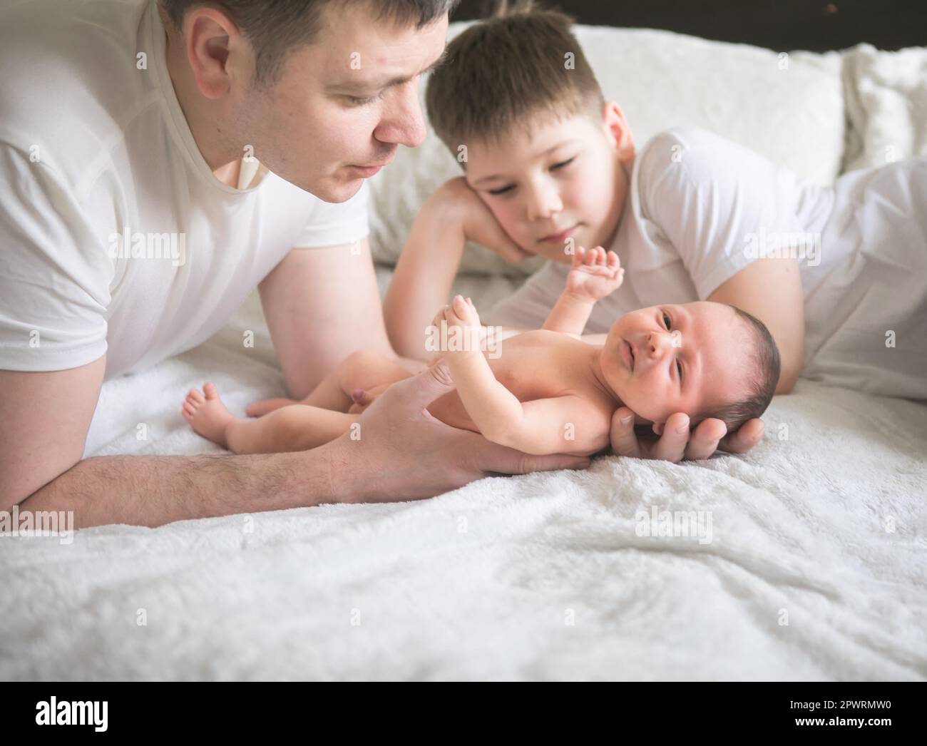 Portrait of father and his four son, holding his newborn baby Stock ...