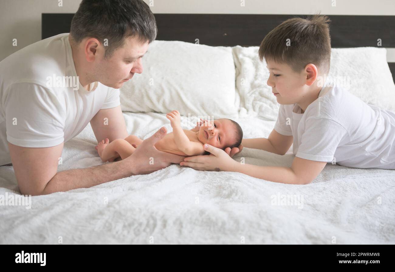 Portrait of father and his four son, holding his newborn baby Stock ...