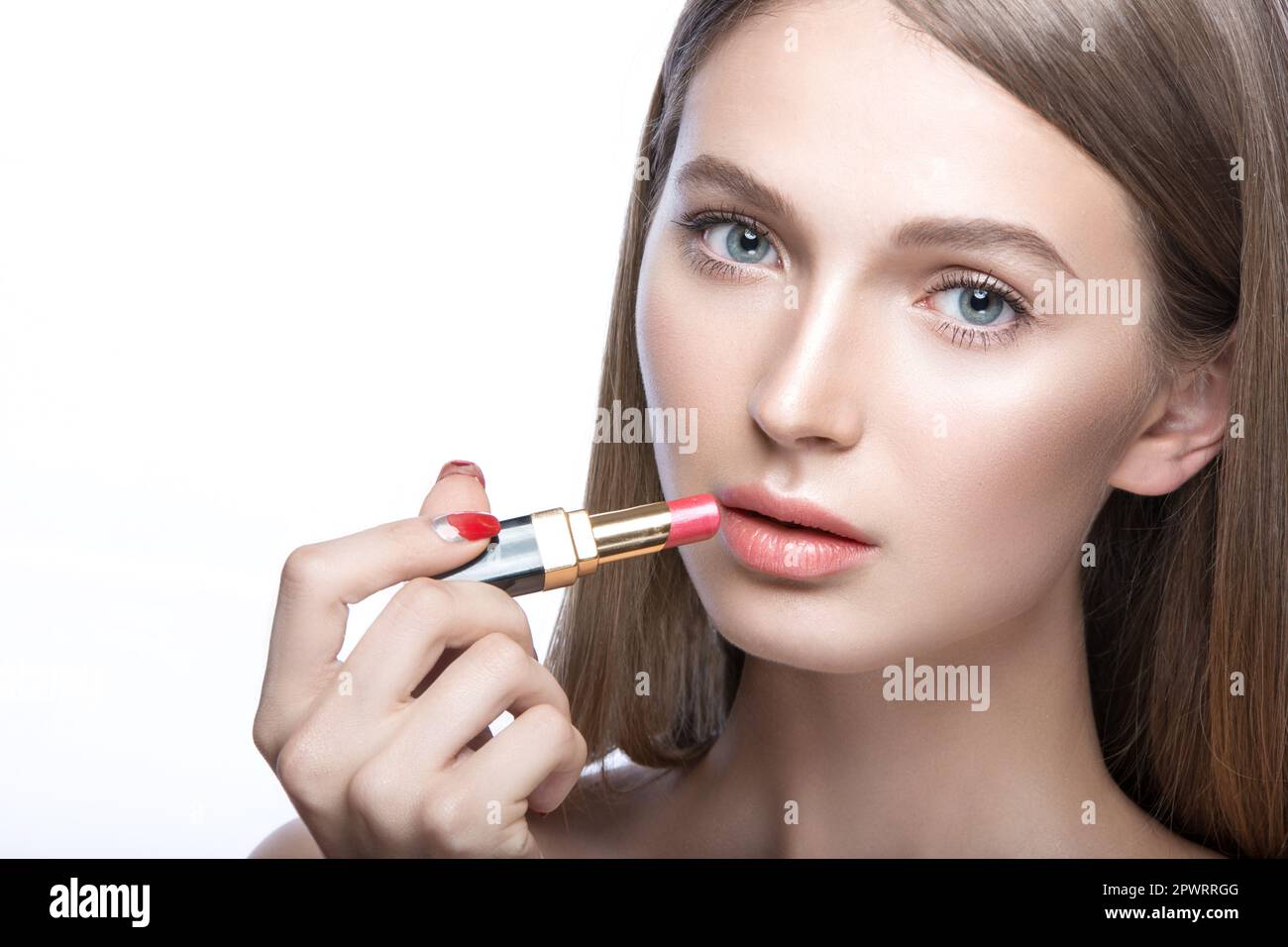 Beautiful young girl with a light natural make-up and beauty tools in ...