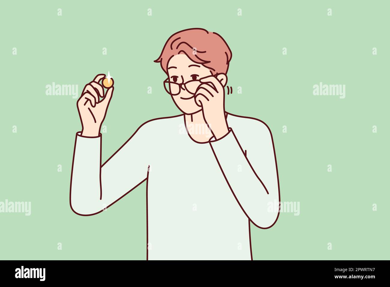 Positive man examines gold coin or piece of jewelry and lowers glasses ...