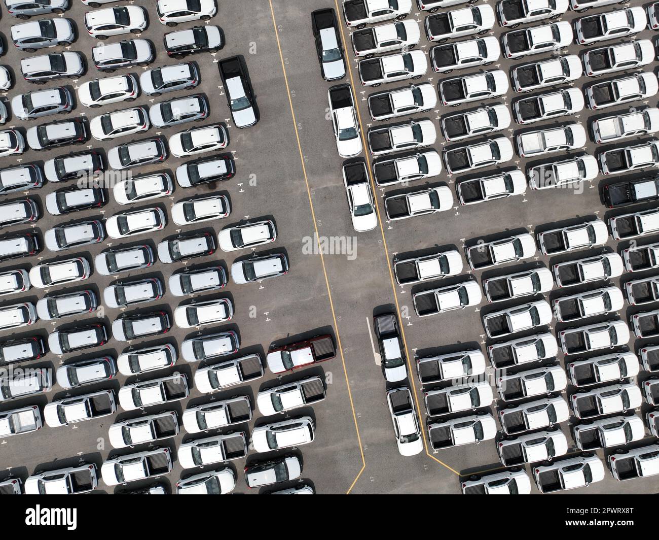 Aerial view of new cars stock at factory parking lot. Above view cars ...