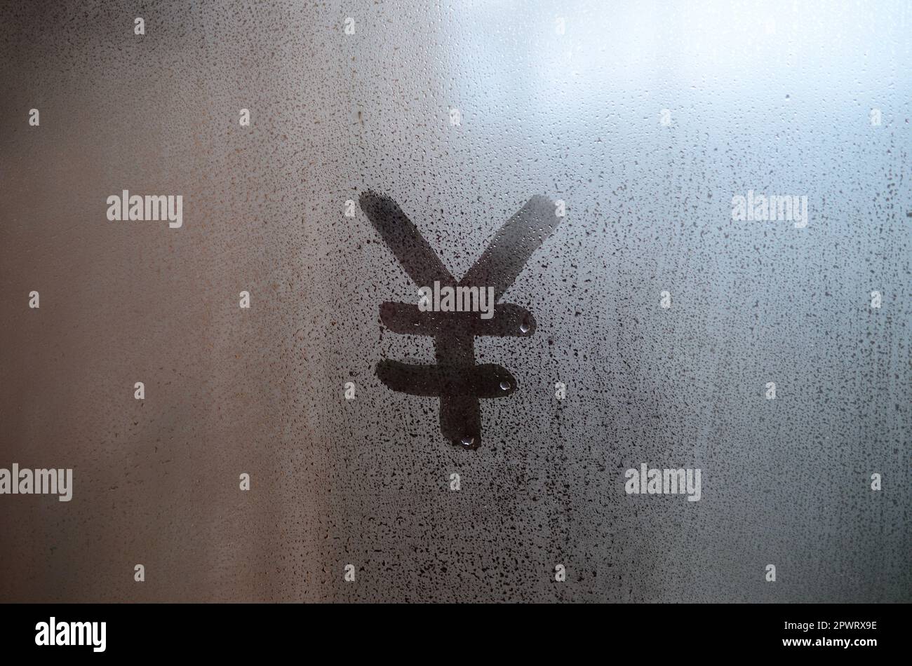 Chinese Yen Symbol is written with a finger on the surface of the ...