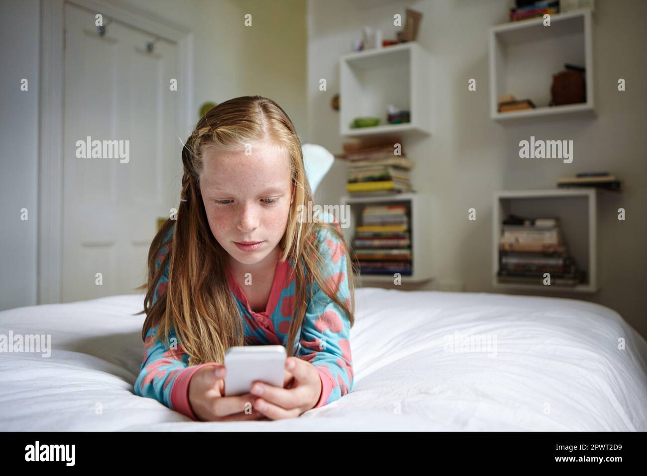 Texting with her friends. a teenage girl texting in her bedroom Stock ...