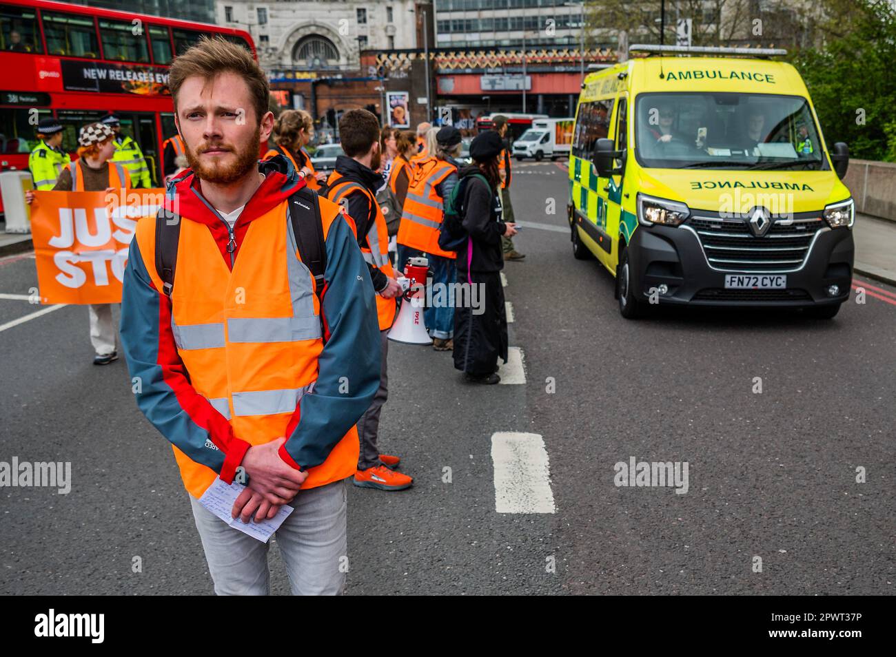 London, UK. 1st May, 2023. The marchers let buses and emergency service ...