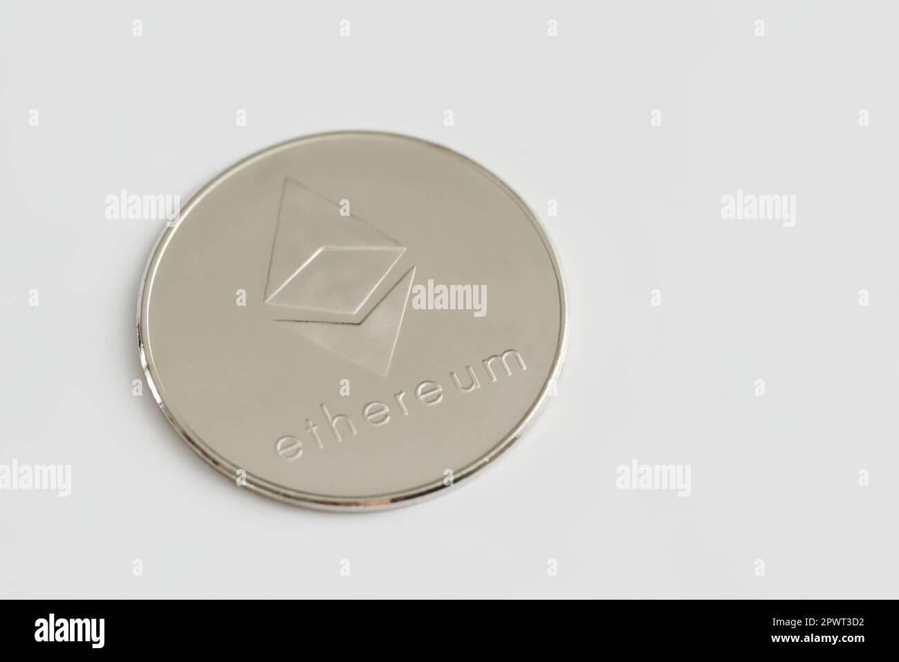 Silver physical Ethereum coin on white background. Digital currency ...
