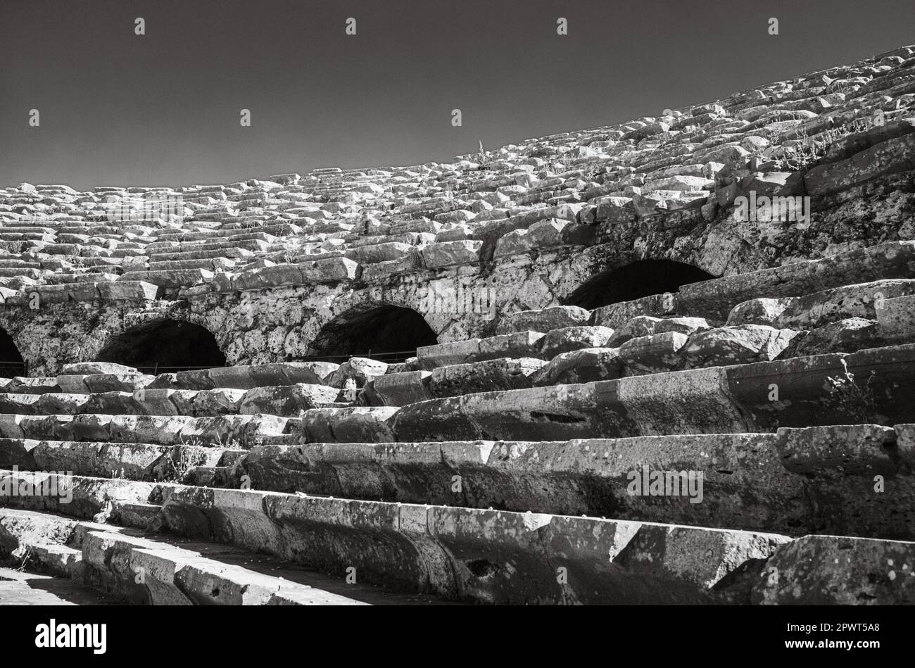Looking up steep steps past rows of stone bench seating at the ...