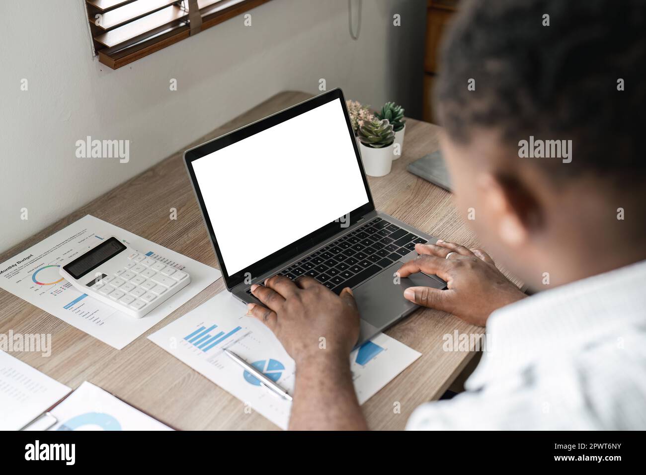 African Americans man using laptop computer with blank empty mockup ...