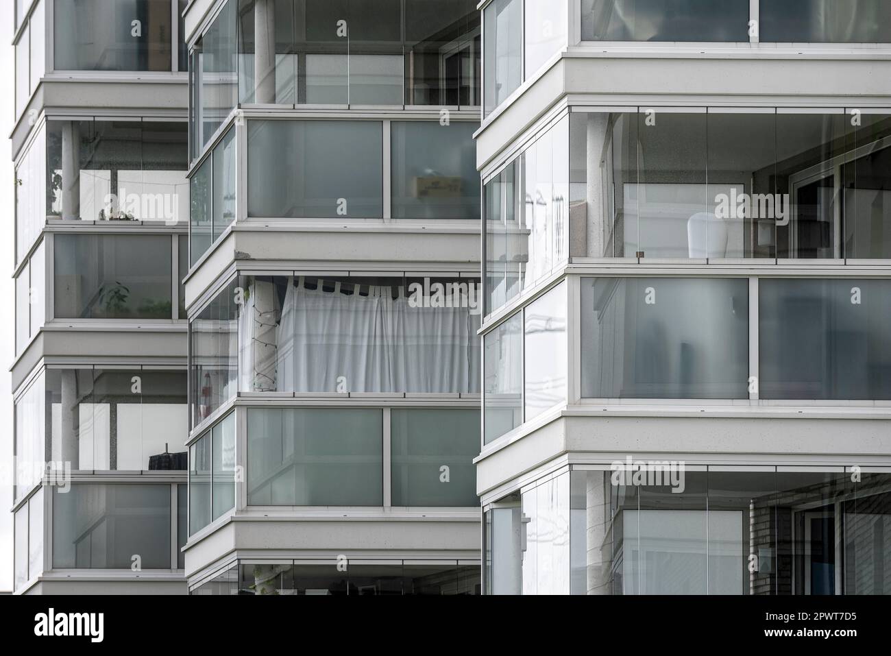 Oblique view of the facade of gray apartment block with balconies ...