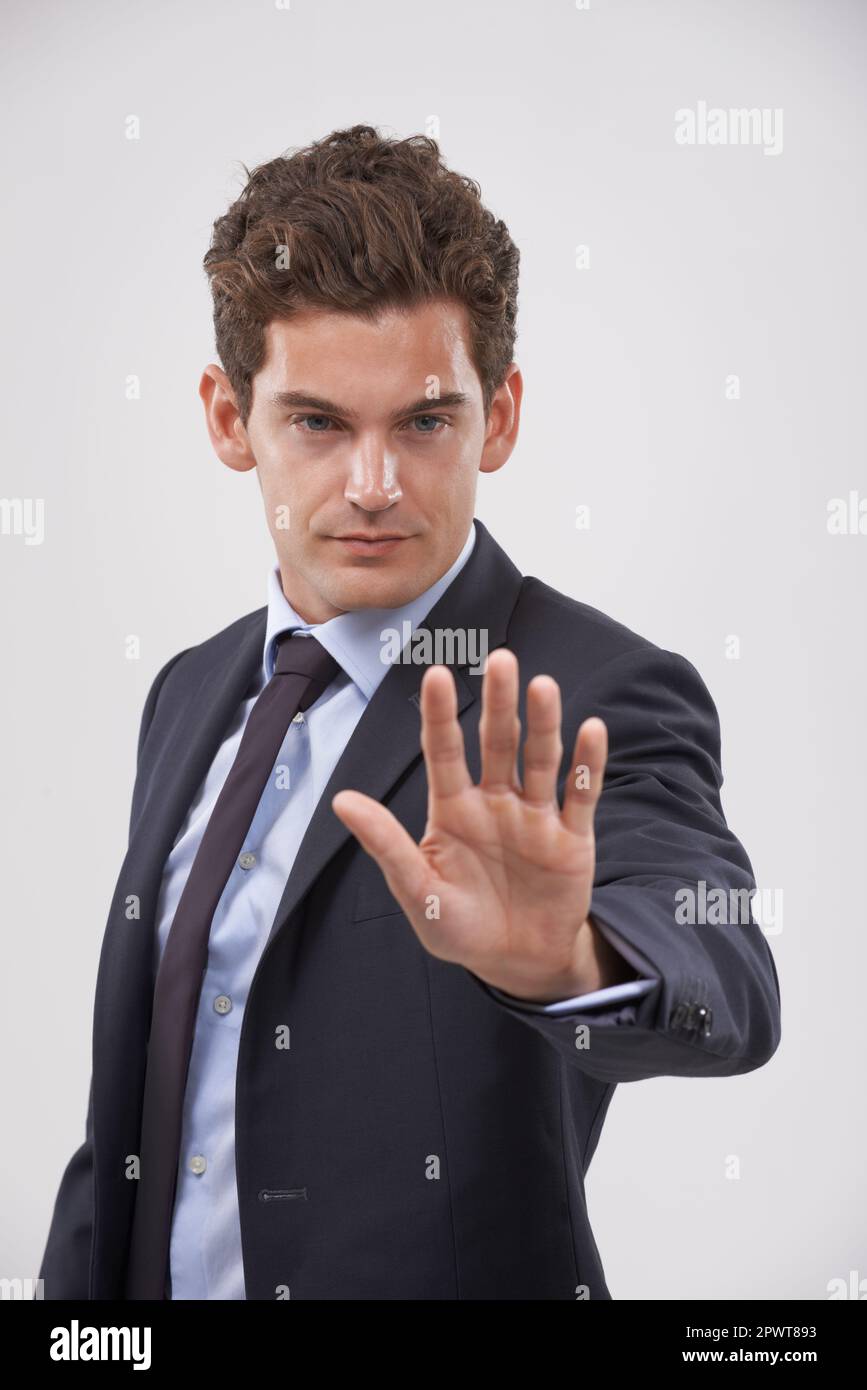 Hold it right there. Businessman holding up his hand in a stop sign ...