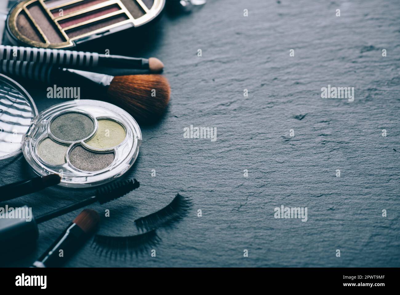 Professional makeup artist set on black background with copyspace. Top ...