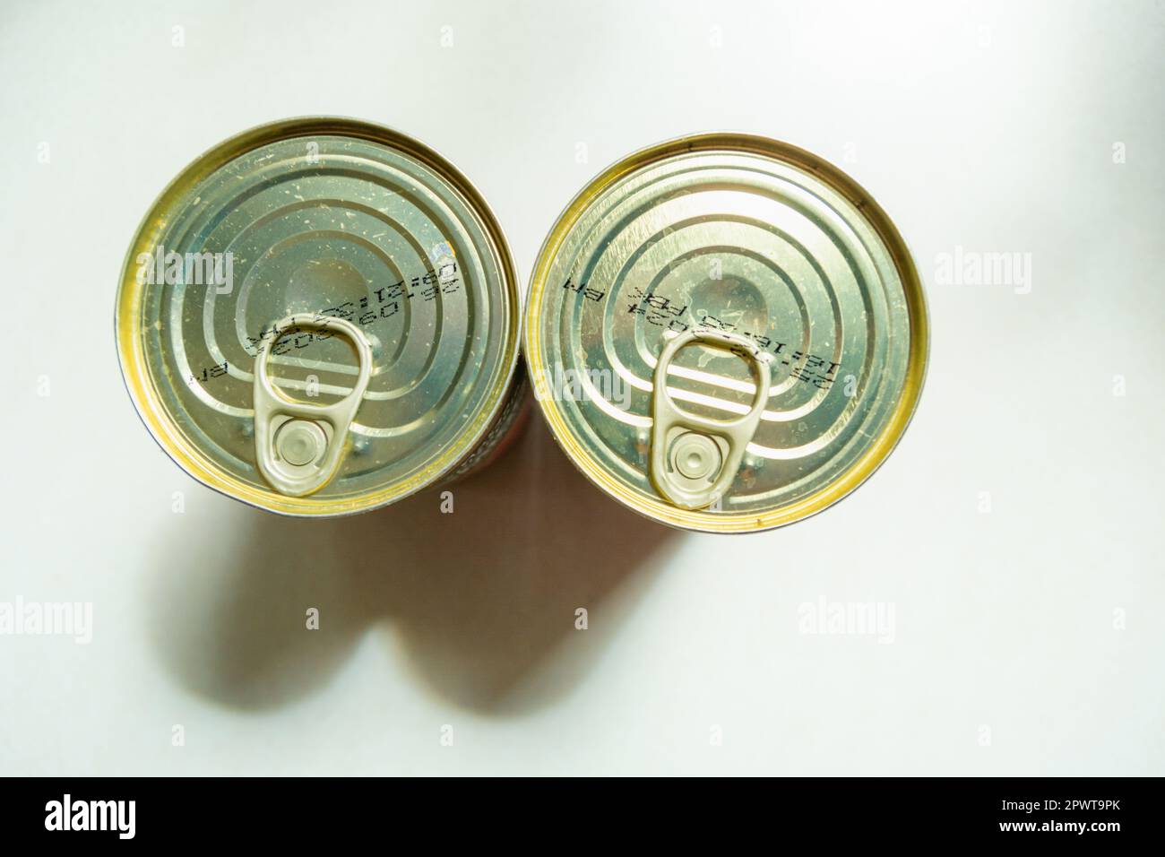 Two dirty cans with food and an opener, top view Stock Photo - Alamy