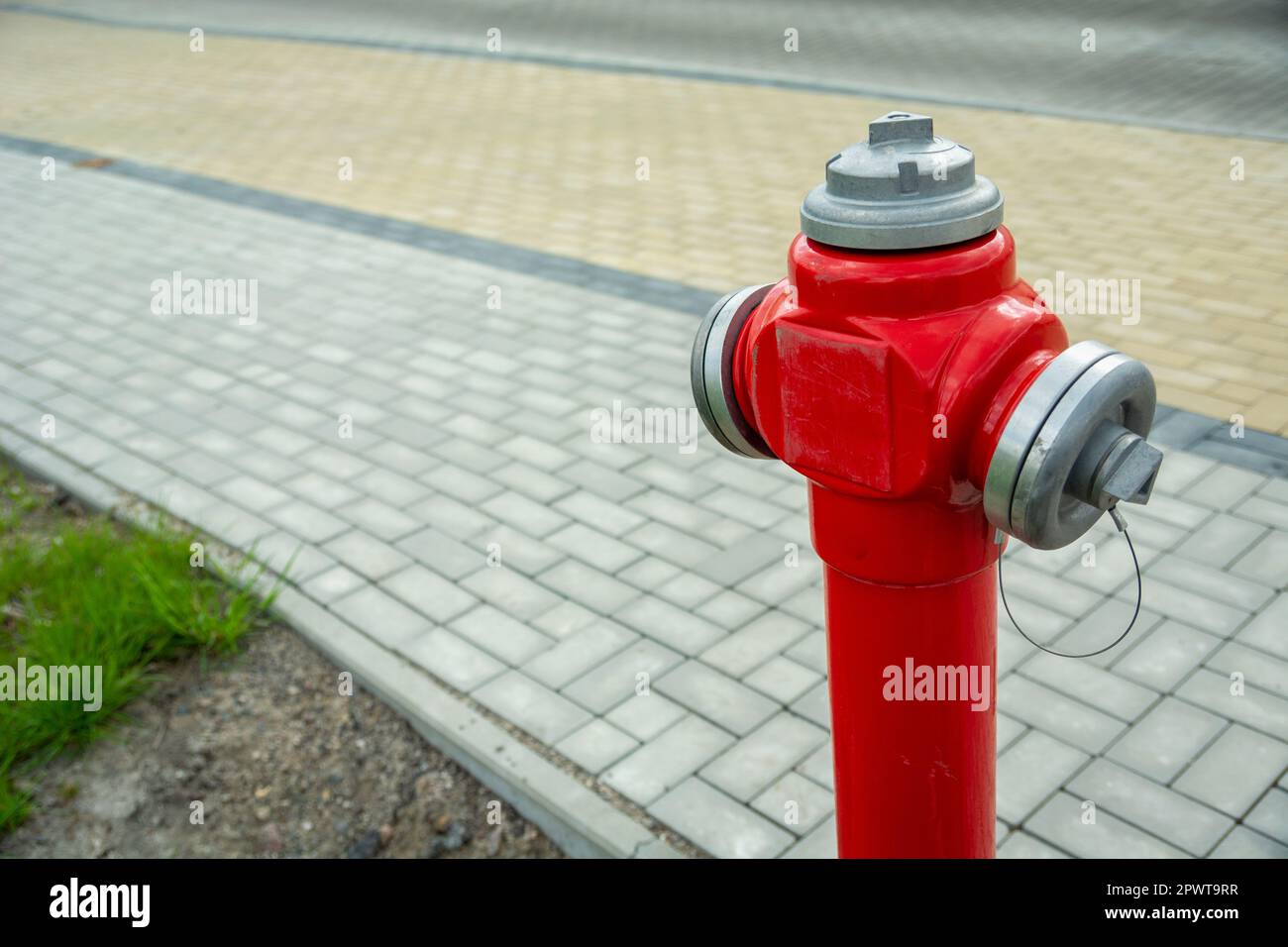 New red fire hydrant standing by the town footpath Stock Photo - Alamy