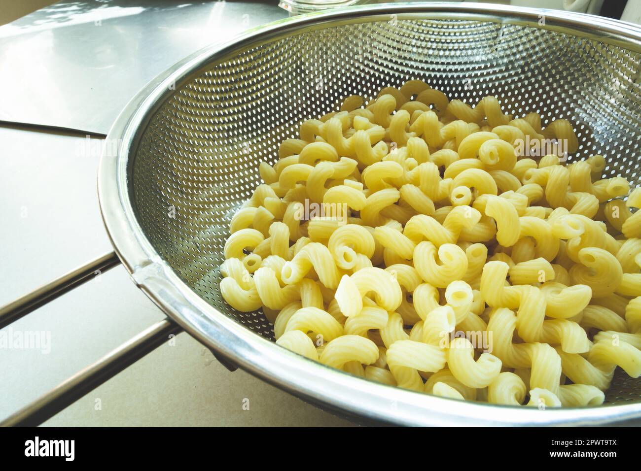 Fresh pasta in a stainless steel silver strainer Stock Photo - Alamy