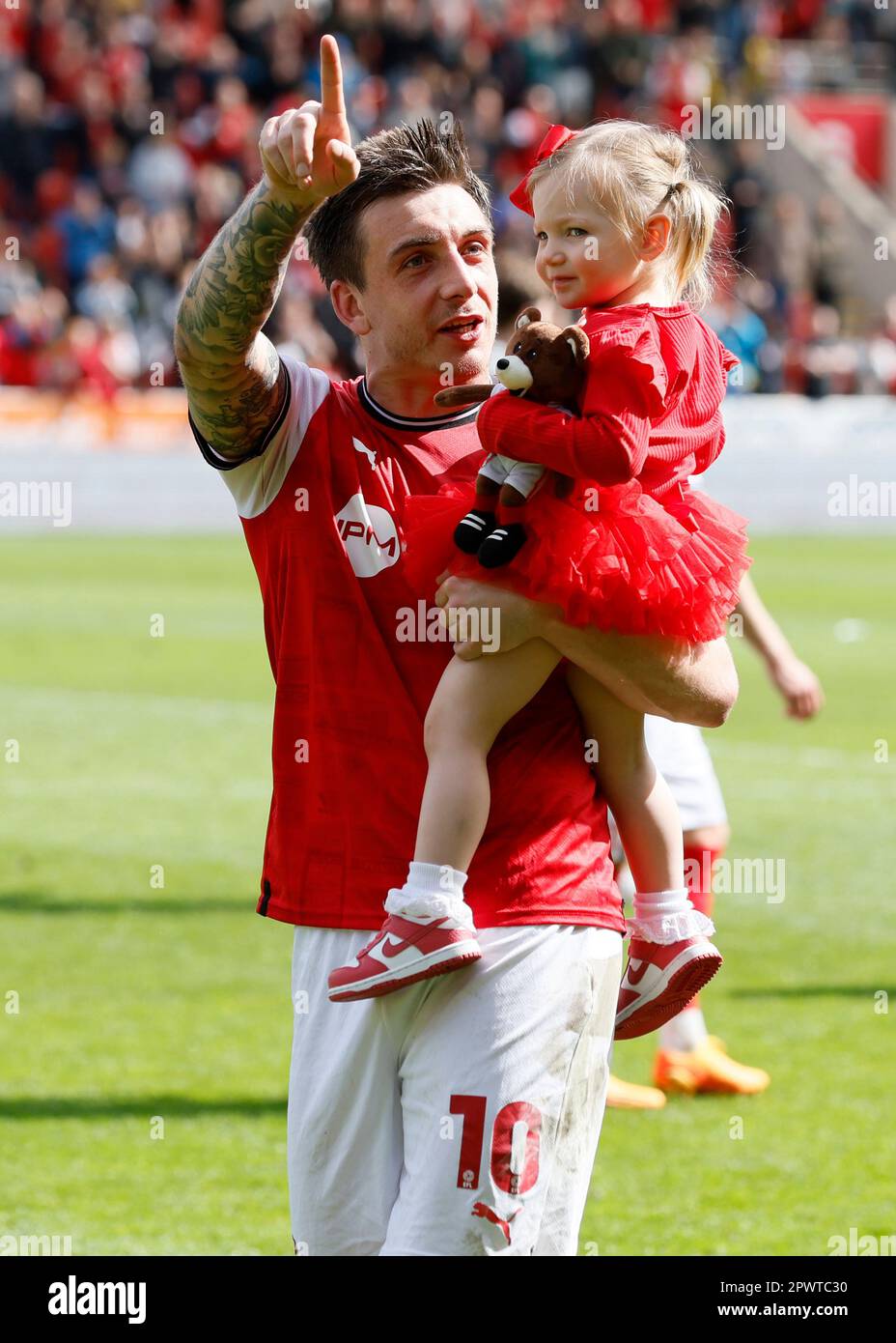 Rotherham United’s Jordan Hugill carries his daughter after their sides ...