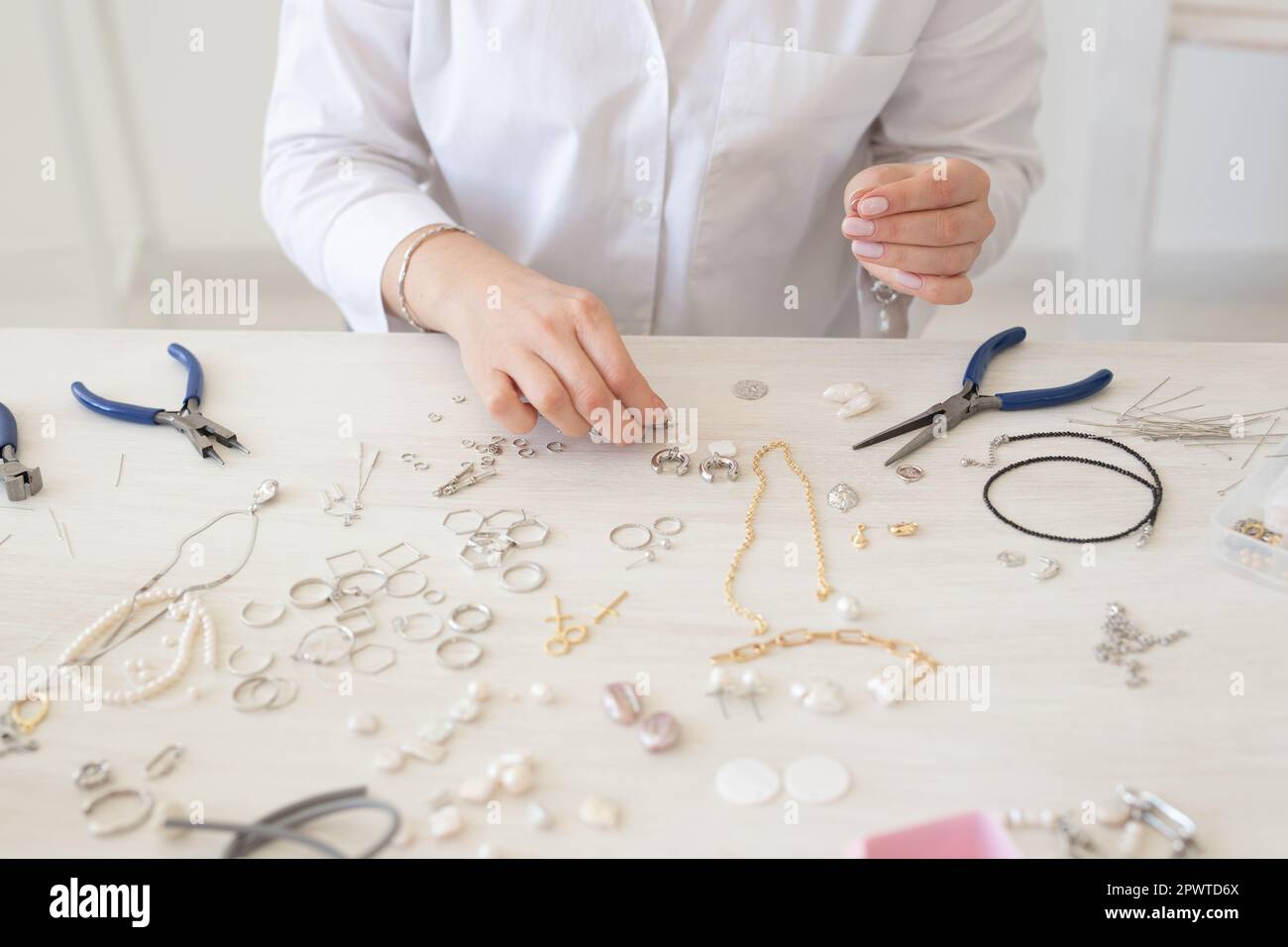 Professional jewelry designer making handmade jewelry in studio ...