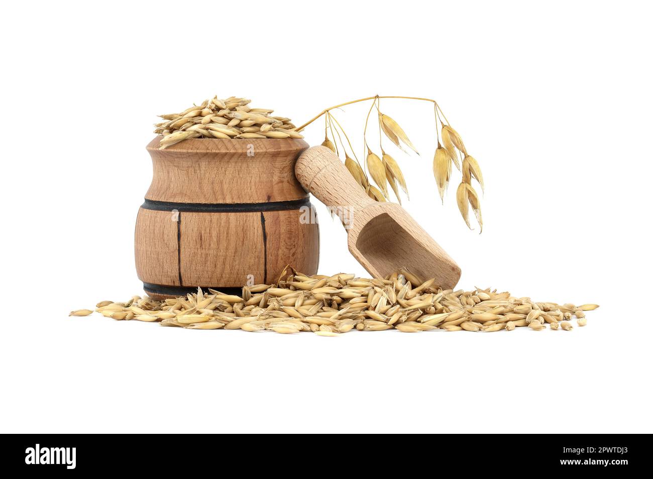 Oat grains with hulls or husks in small wooden barrel isolated on a ...