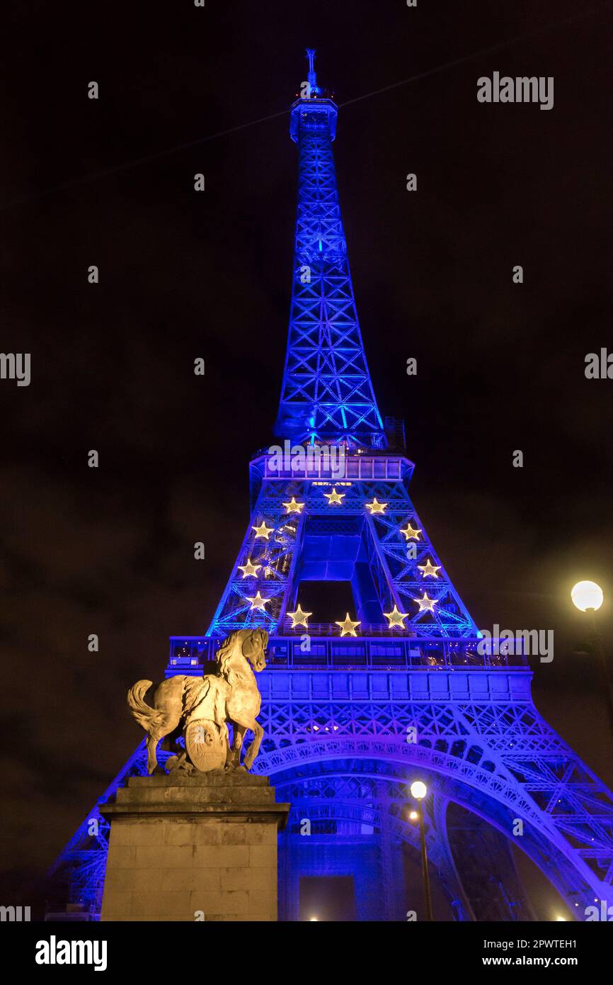 The iconic Eiffel Tower illuminated at night, wrought-iron lattice tower on the Champ de Mars in ...