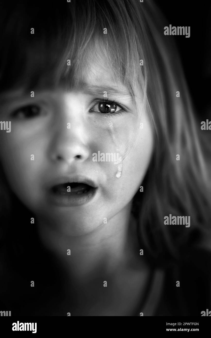 Portrait of little girl crying with tears rolling down her cheeks dramatic and emotional sadness ...