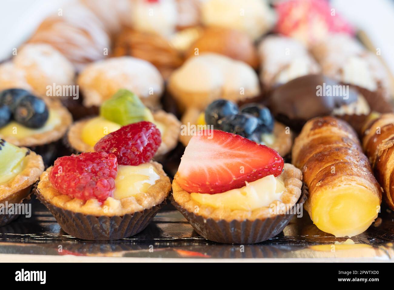 Assortment of delicious and colorful pastries close up, made by pastry ...