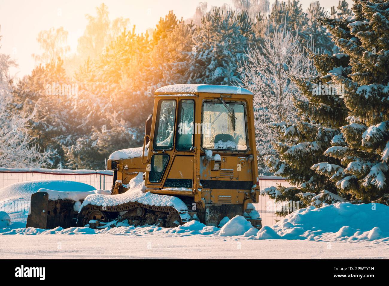 Bulldozer standing on the snow in winter. Snow removal equipment. Snow ...