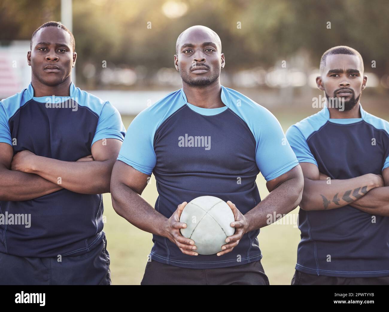 Portrait three young african american rugby players holding a rugby ...