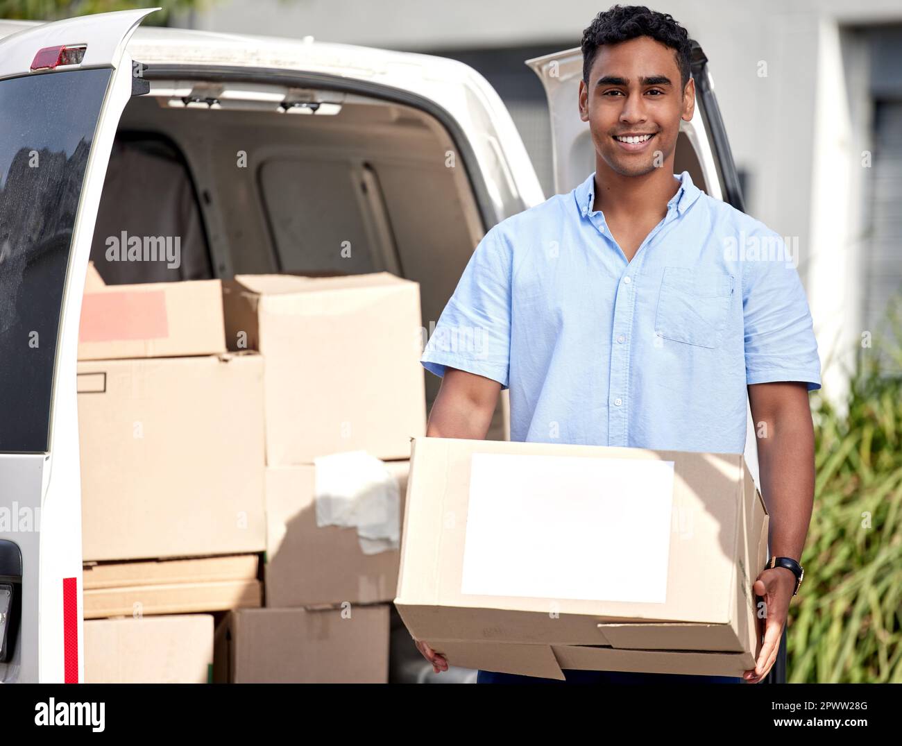 Ill get this to you in a flash. Portrait of a young delivery man ...