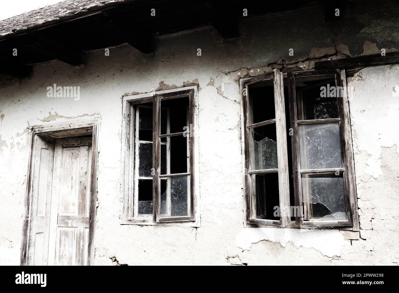 Abandoned spooky old house. Wooden windows and doors. The hut is a mud ...