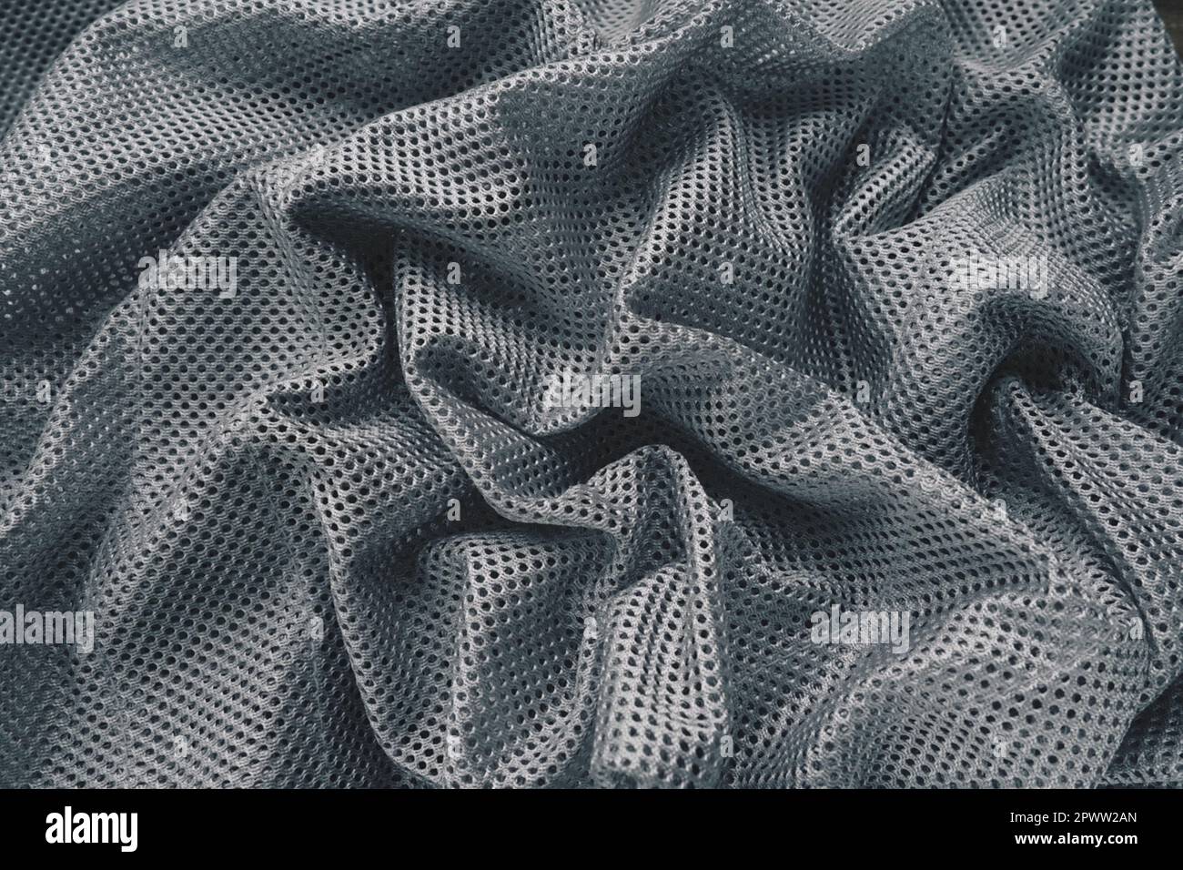 Synthetic fabric with holes laid in waves. Beautiful drape. Fabric for ...