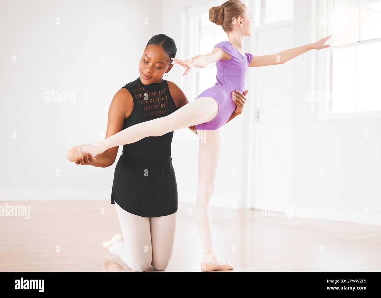Define your dance. a little girl practicing ballet with her teacher in ...