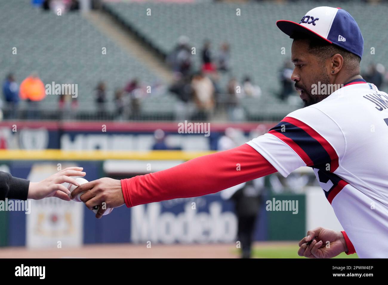 Chicago White Sox's Eloy Jimenez, right, returns his autographs ball to ...