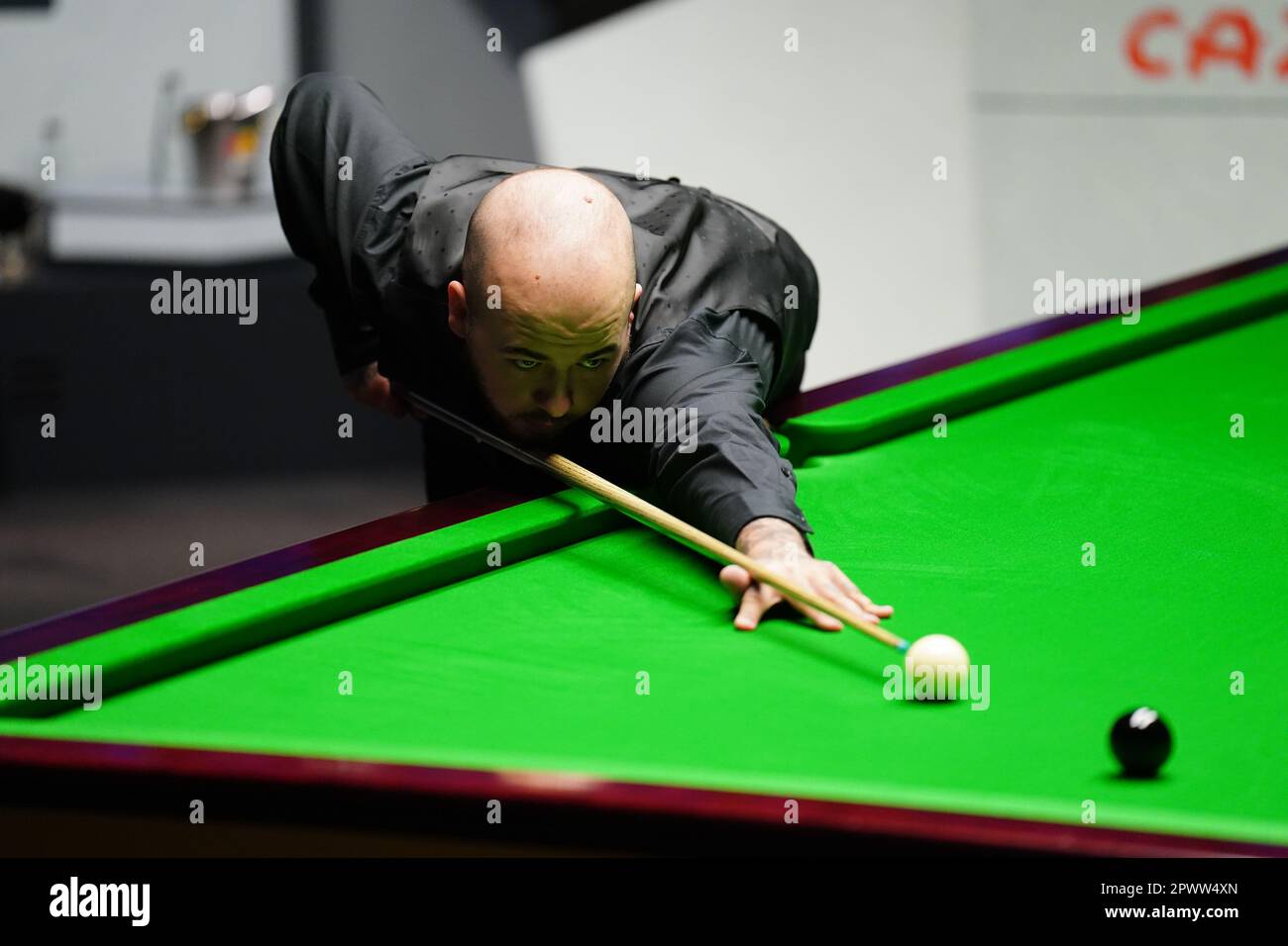 Luca Brecel in action against Mark Selby (not pictured) during the ...