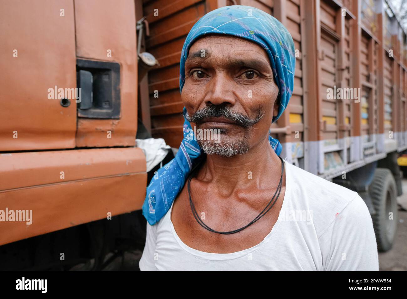 Kolkata, India. 21st Mar, 2023. A labourer poses for a photo at the ...