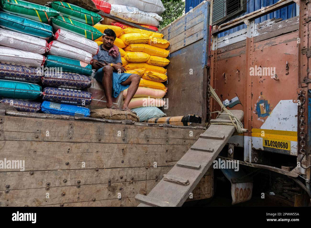 Kolkata, India. 21st Mar, 2023. A labourer seen resting in a truck ...