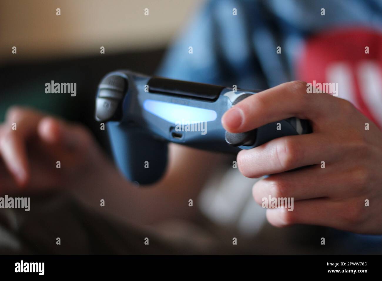 Blue video Game controller in Action, Young man playing video games on ...