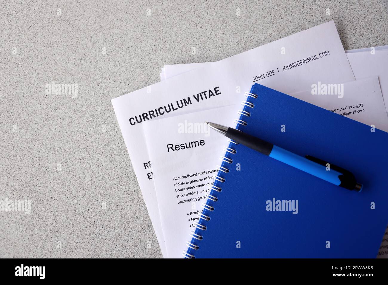Top view of stack of office documents including resume and cv forms on ...