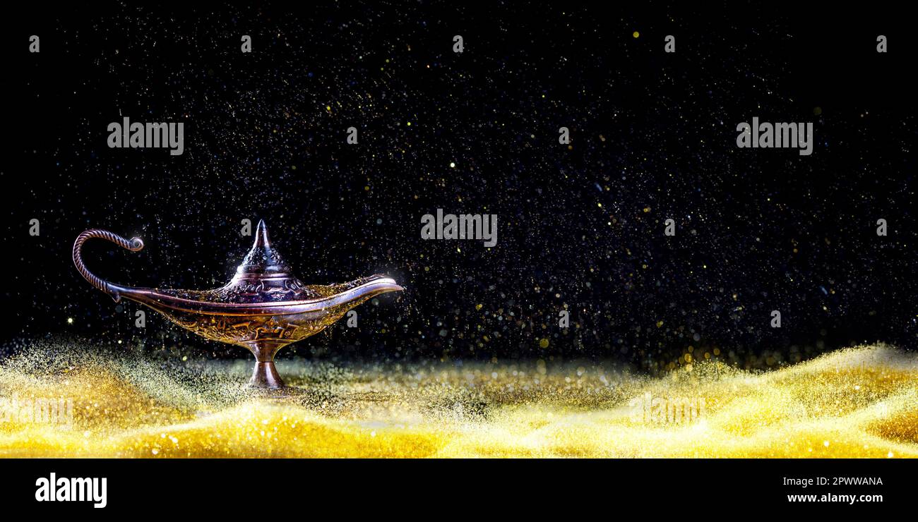 aladdin's lamp and gold dust, black background Stock Photo - Alamy
