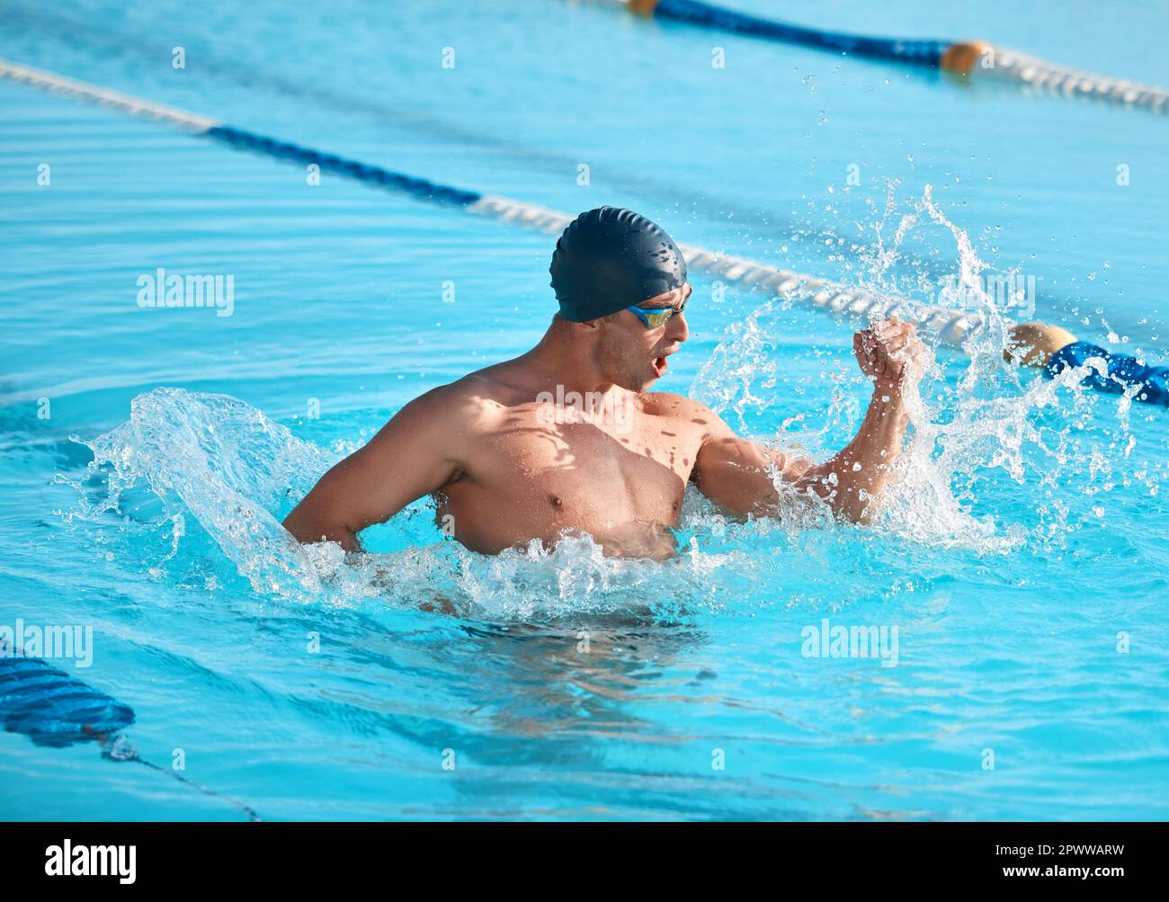 A personal best. a handsome young male athlete swimming in an olympic ...