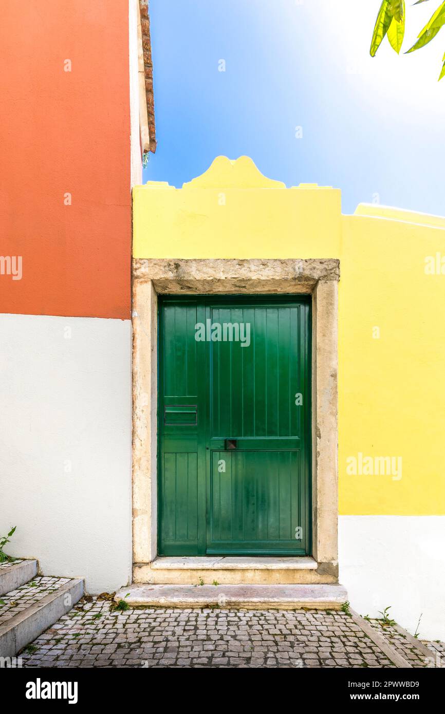 Lisbon, Portugal - April 25, 2023: Beautiful green door with a yellow ...