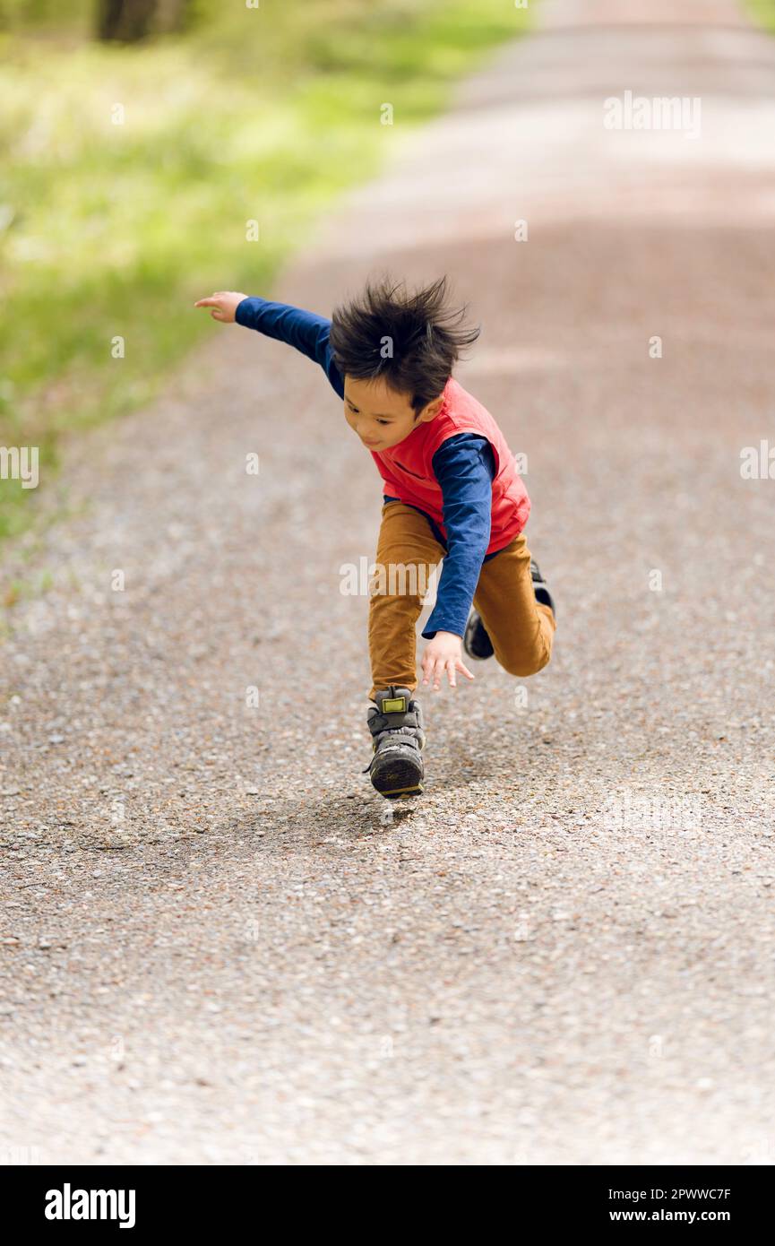 A boy ran and stumbled on a forest path Stock Photo - Alamy
