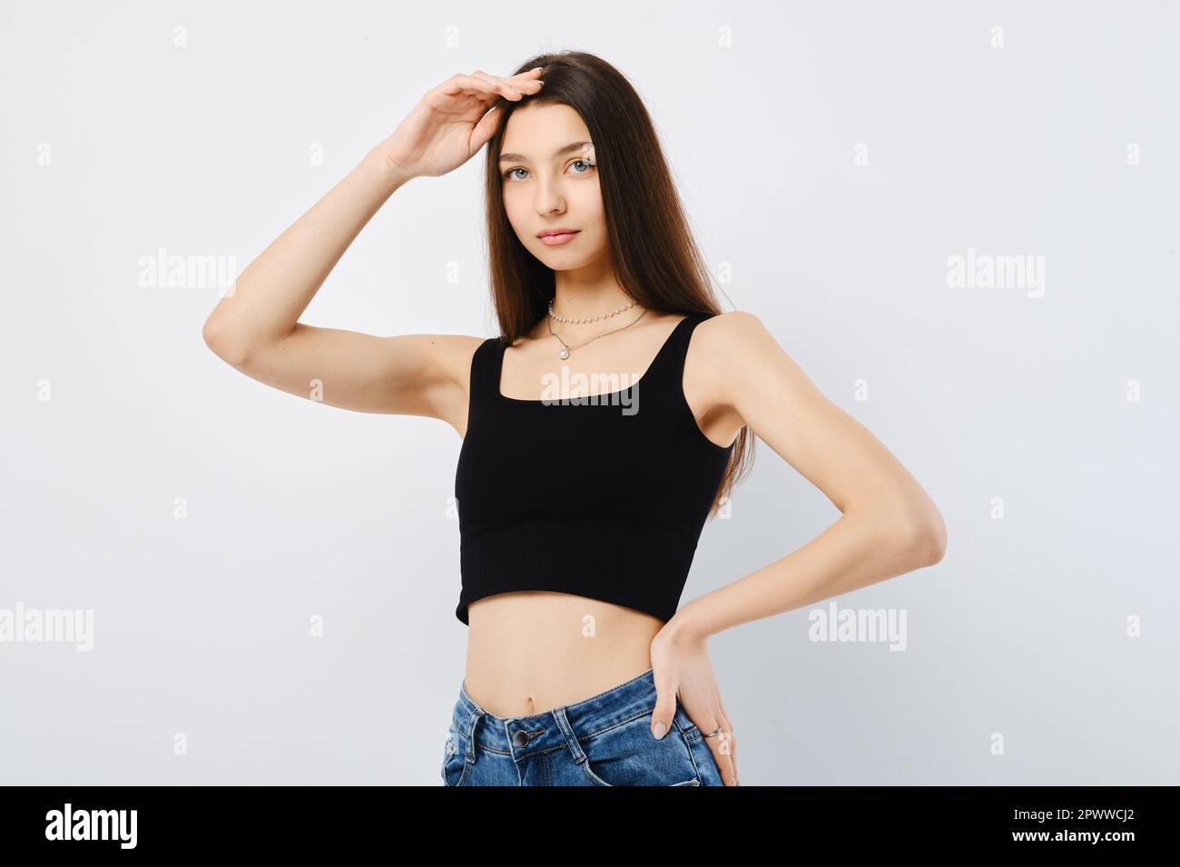 Portrait of young model in black tank top over white background Stock ...