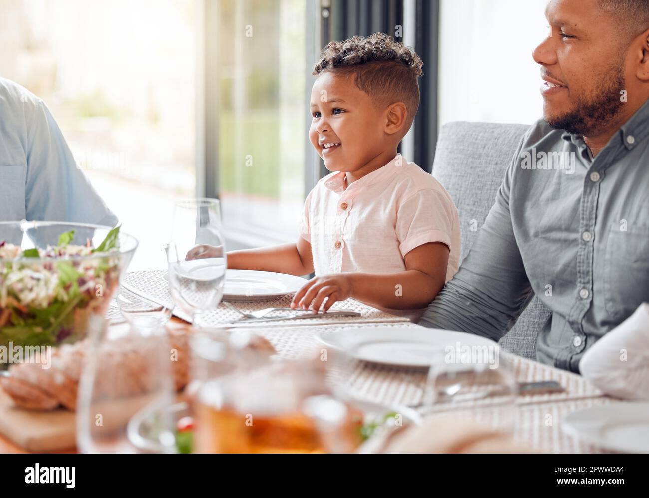 Hes ready to eat. a family having lunch together at home Stock Photo ...