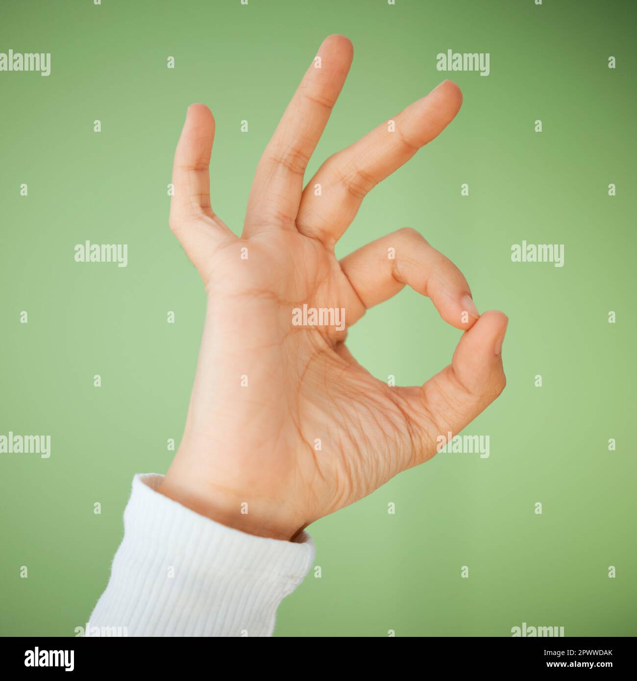 Im okay with that. an unrecognizable woman showing the OK sign against ...