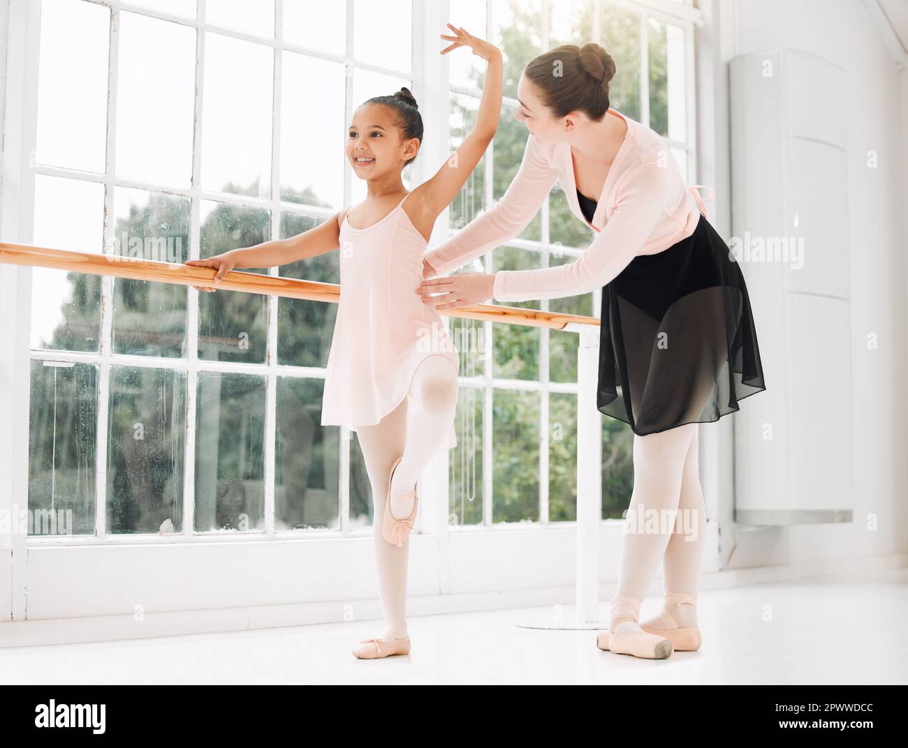 Its all in the posture. a little girl practicing ballet with her ...