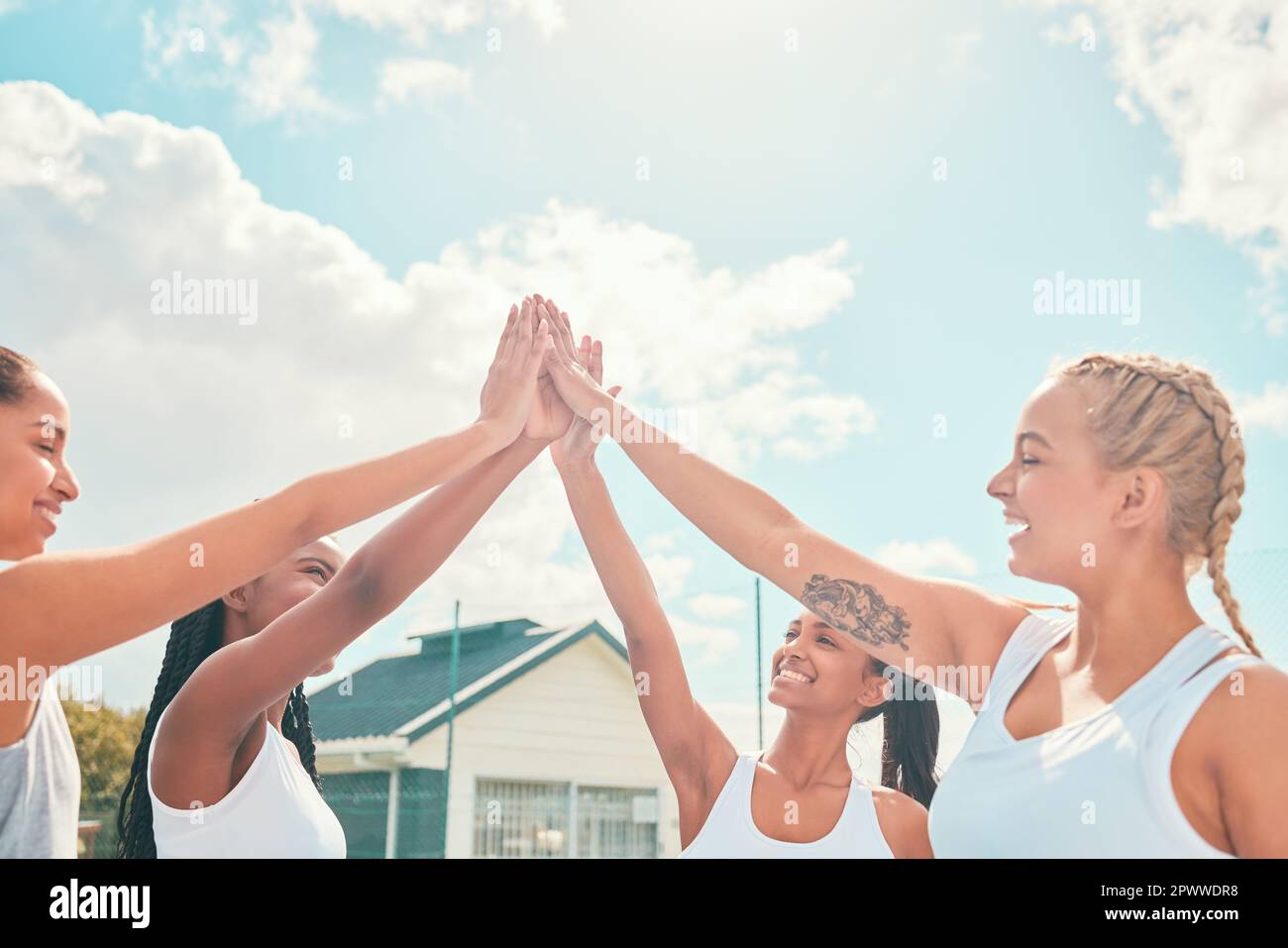 Lets win this thing. a diverse group of women standing together with ...