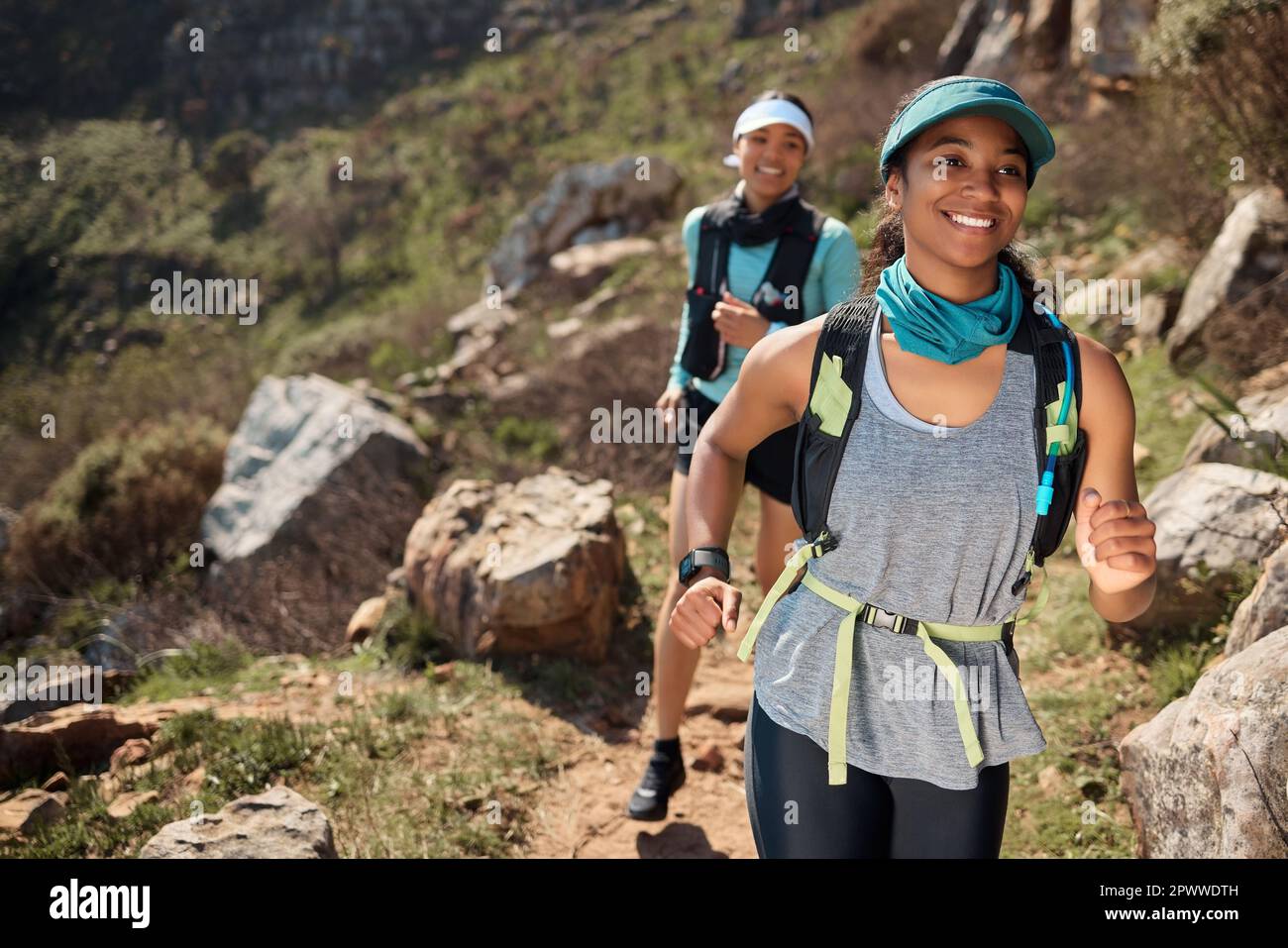 Best friends keep each other fit. two young women running along a trail ...