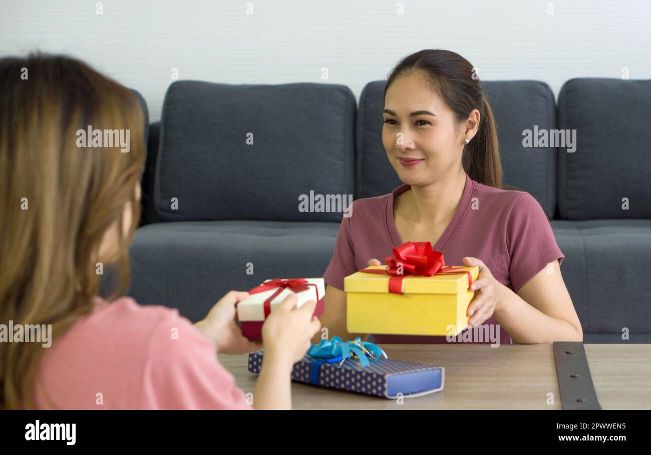 Asian couple giving gift boxes hi-res stock photography and images - Alamy