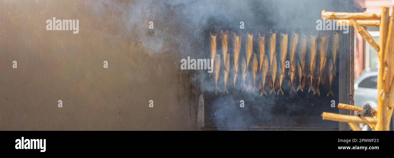 Advertising banner with the process of processing fish by smoking ...
