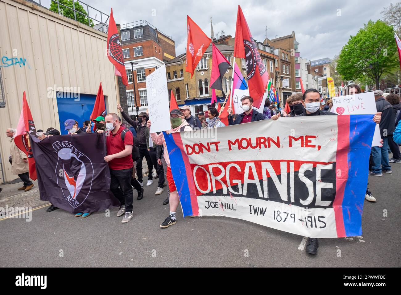 London, UK. 1 May 2023. IWW march with a banner with Joe Hill's message ...